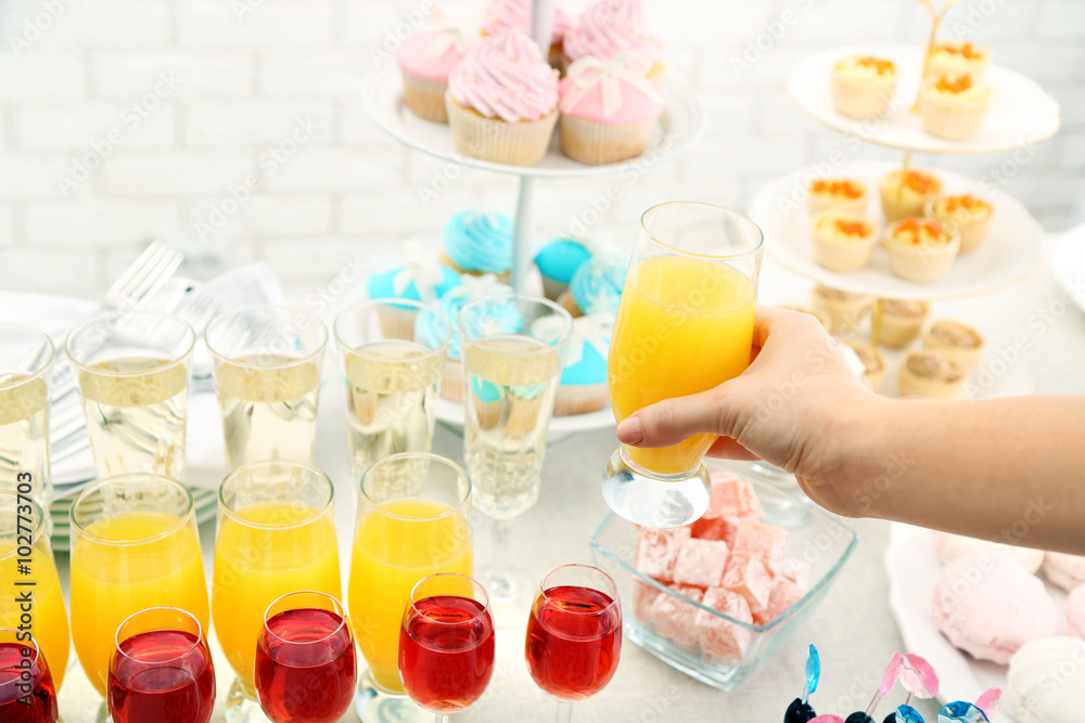 Woman holding glass of juice on buffet background Stock Photo | Adobe Stock