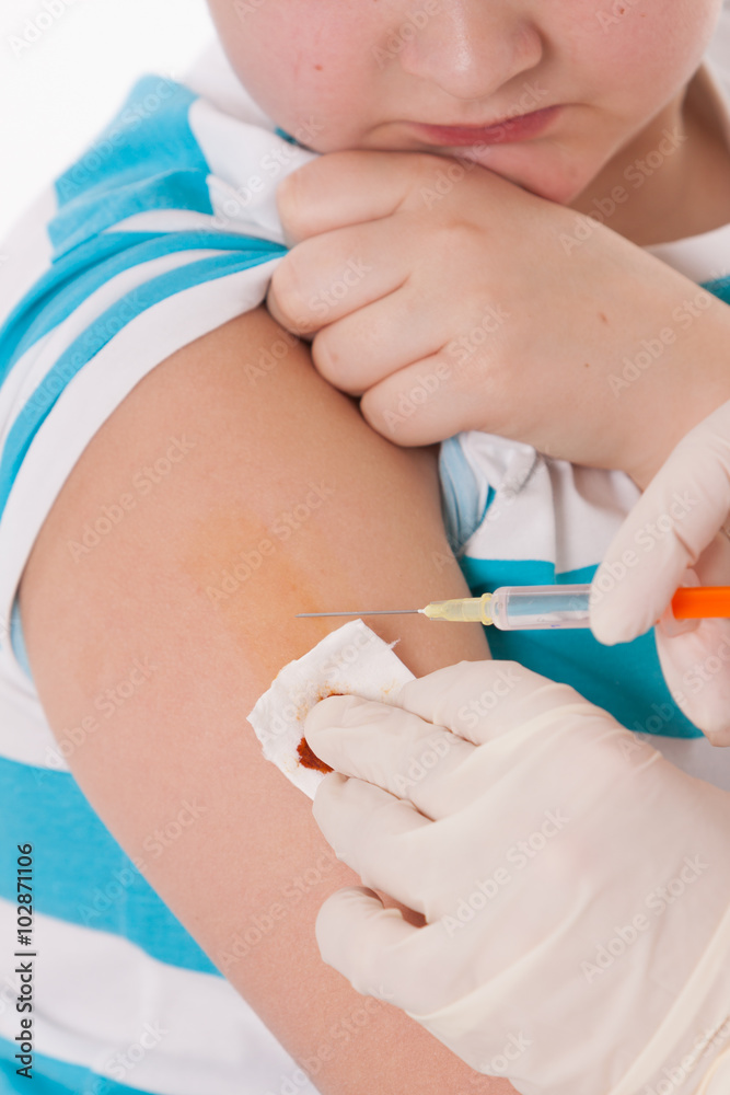 Doctor giving a child injection in arm on isolated image. Stock Photo ...
