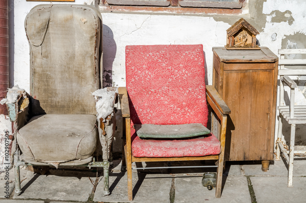Two old vintage retro broken reclining seats on a background of white ...