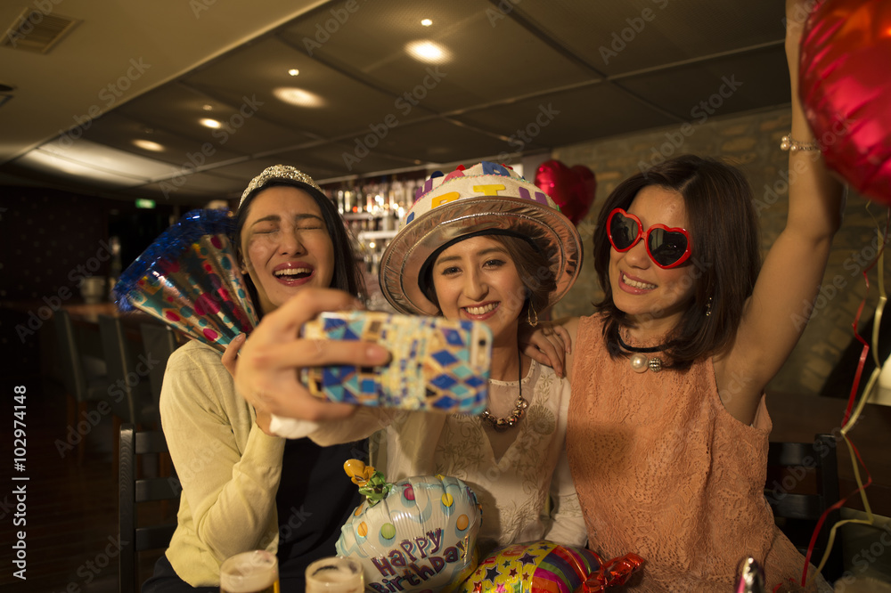 Three women are celebrating a birthday at the bar Stock Photo | Adobe Stock
