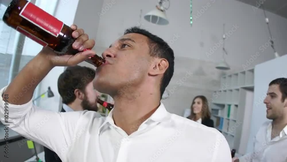 Drunk office worker drinking beer, dancing and taking a selfie with his ...