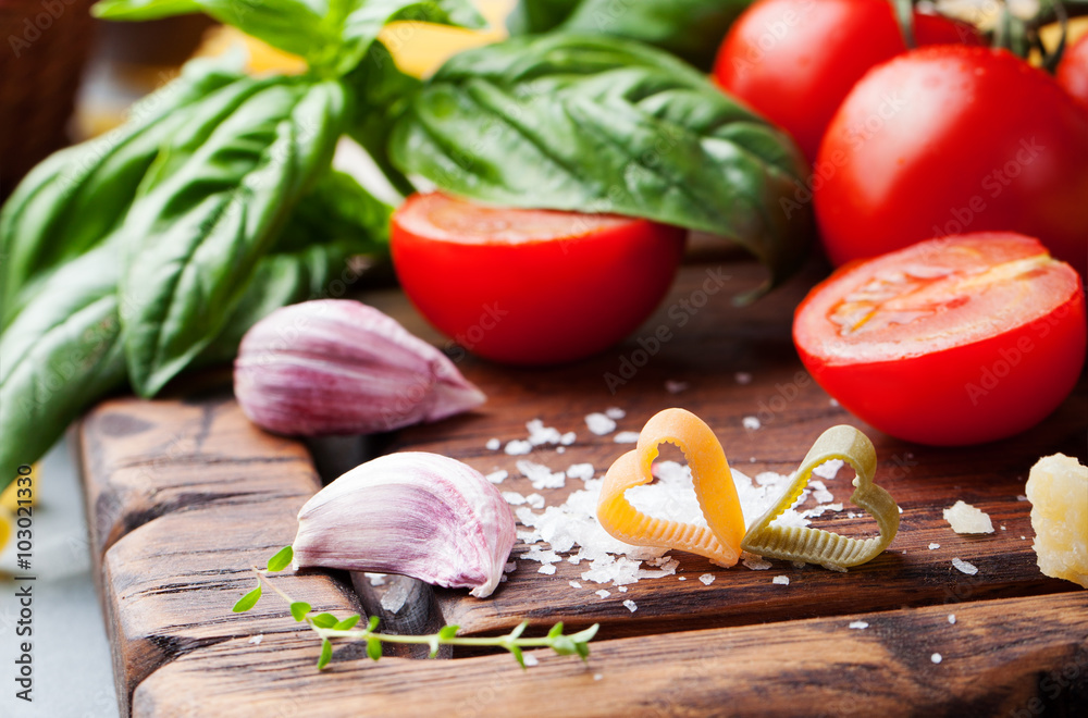 Italian food background with vine tomatoes, basil, spaghetti, olives ...
