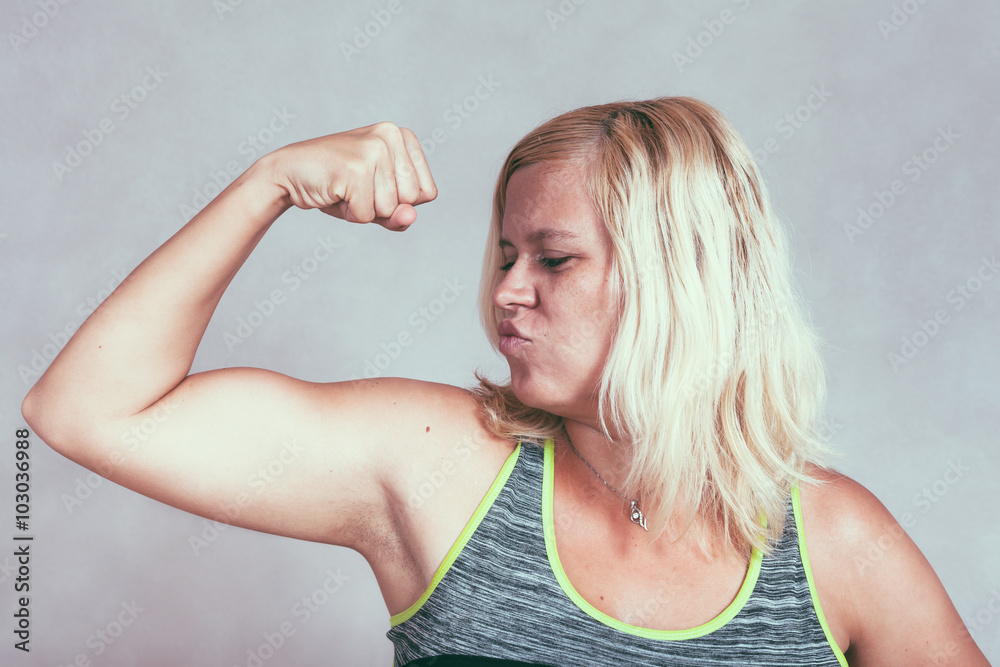 Strong muscular sporty woman flexing biceps Stock Photo | Adobe Stock