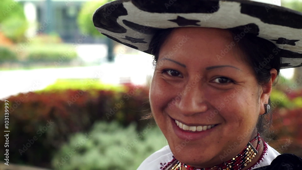 Close up side portrait shot of an indigenous Saraguro woman smiling and ...