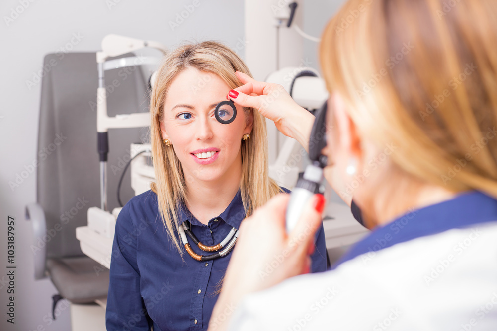 Woman at eye doctors office checking her vision Stock Photo | Adobe Stock