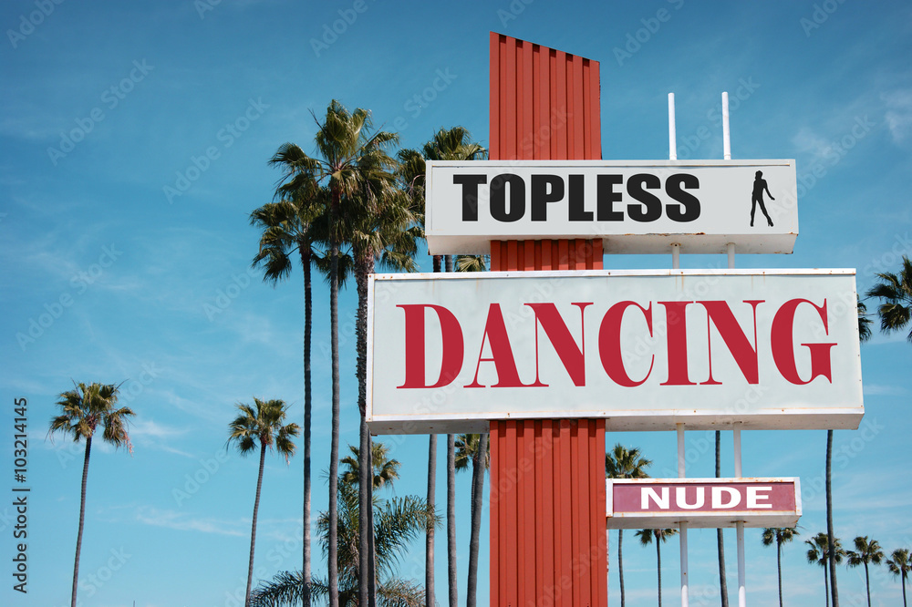 aged and worn vintage photo of exotic dancing sign with palm trees ...