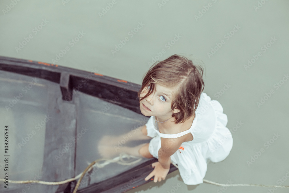 Beautiful young girl in the sinking boat. Stock Photo | Adobe Stock
