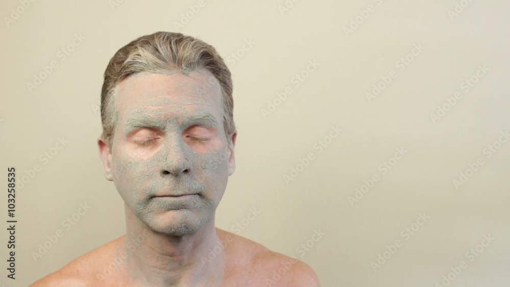 Man Wearing a Green Clay Mask. Adult caucasian male wearing a drying ...