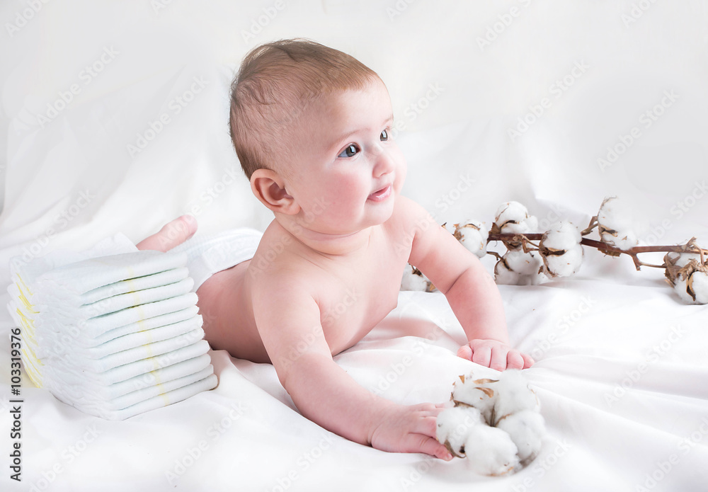 Baby in diaper on a white background with a branch of cotton Stock ...