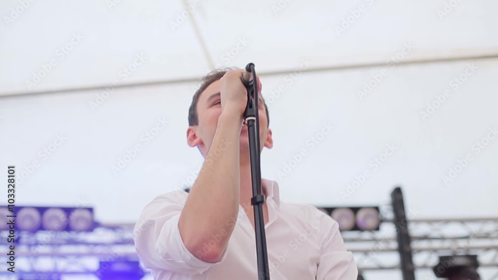 Man performing on the stage and sings. Stock ビデオ | Adobe Stock