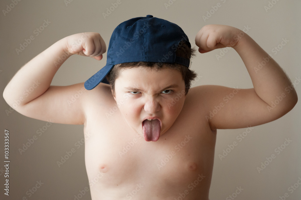 Fat Boy In Cap Showing Muscles And Tongue Giant Powerful Stock Photo fat-boy-in-cap-showing-muscles-and-tongue-giant-powerful-stock-photo