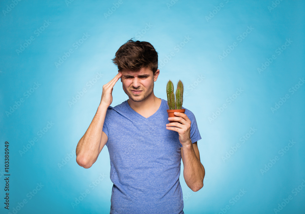 concept with a man holding a cactus Stock Photo | Adobe Stock