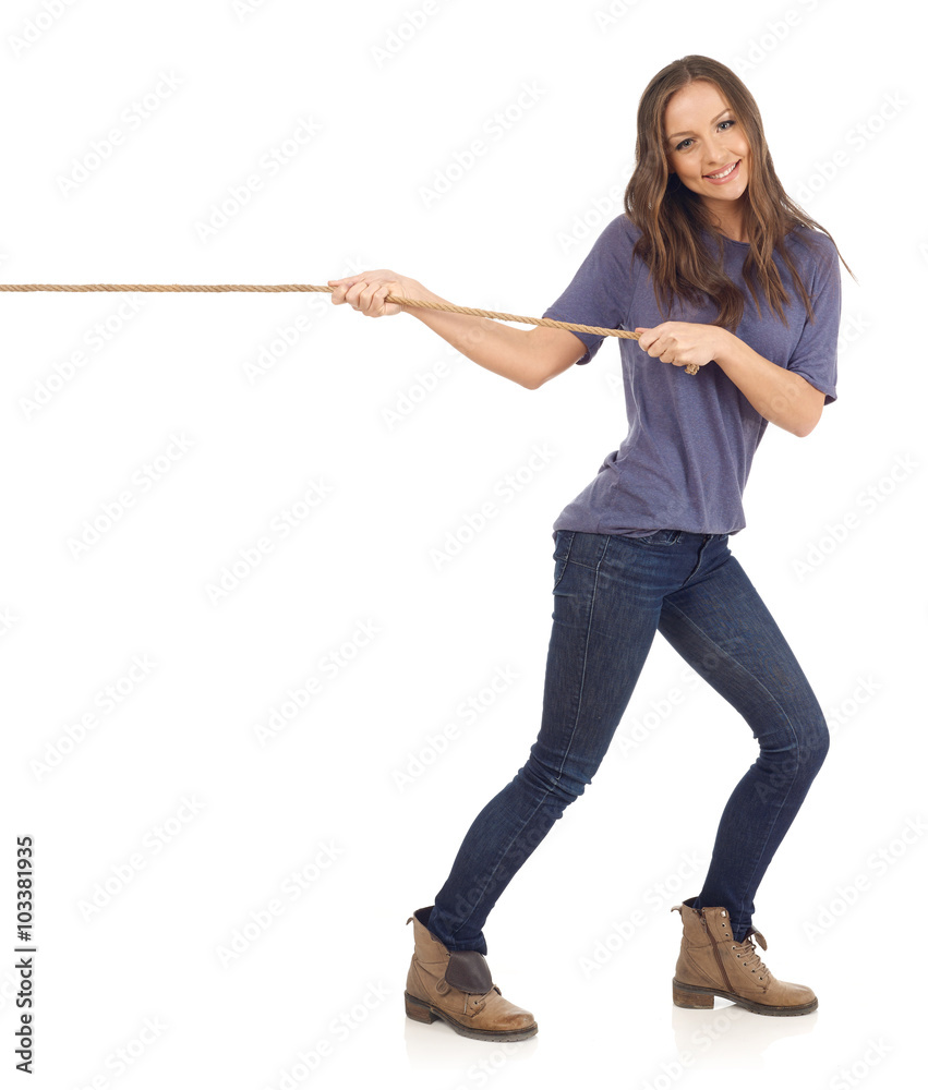 Woman pulling a rope Stock Photo | Adobe Stock