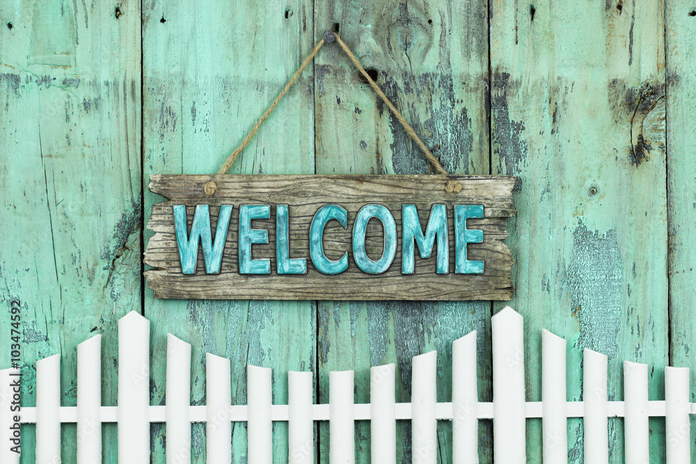 Welcome sign hanging over white picket fence Stock Photo | Adobe Stock