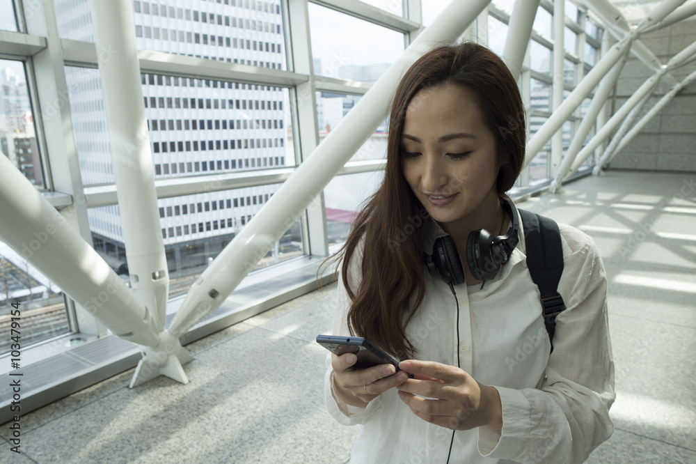 Beautiful woman looking at the smartphone in a modern building Stock ...