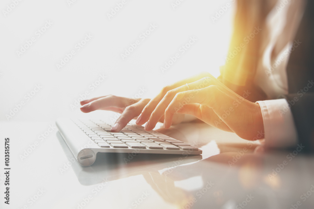 Closeup photo of female hands typing text on a wireless keyboard ...