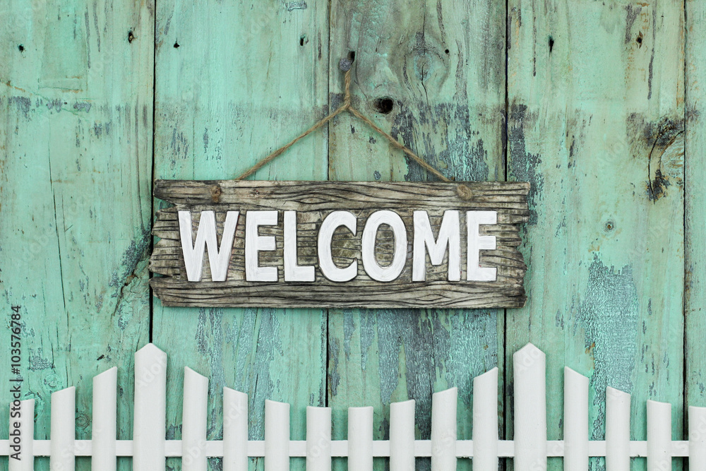 Welcome sign hanging over white picket fence Stock Photo | Adobe Stock