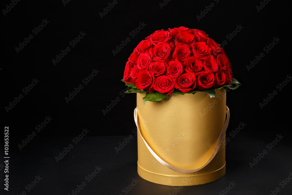 Romantic red roses in a gold gift box to place the logo on a black ...