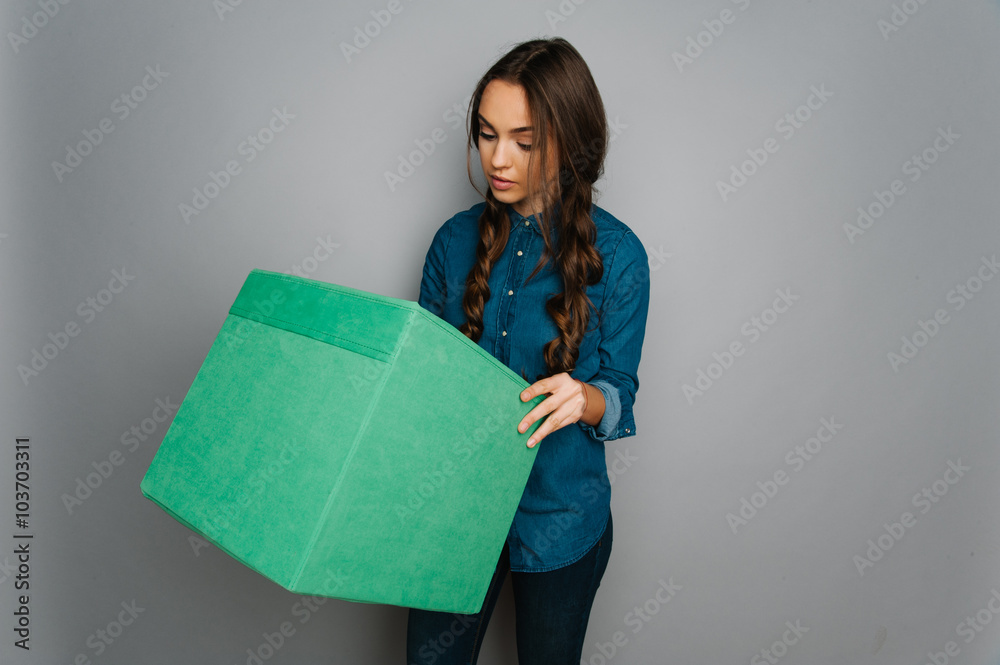 Attractive cute caucasian girl holding big square box in her hand ready ...