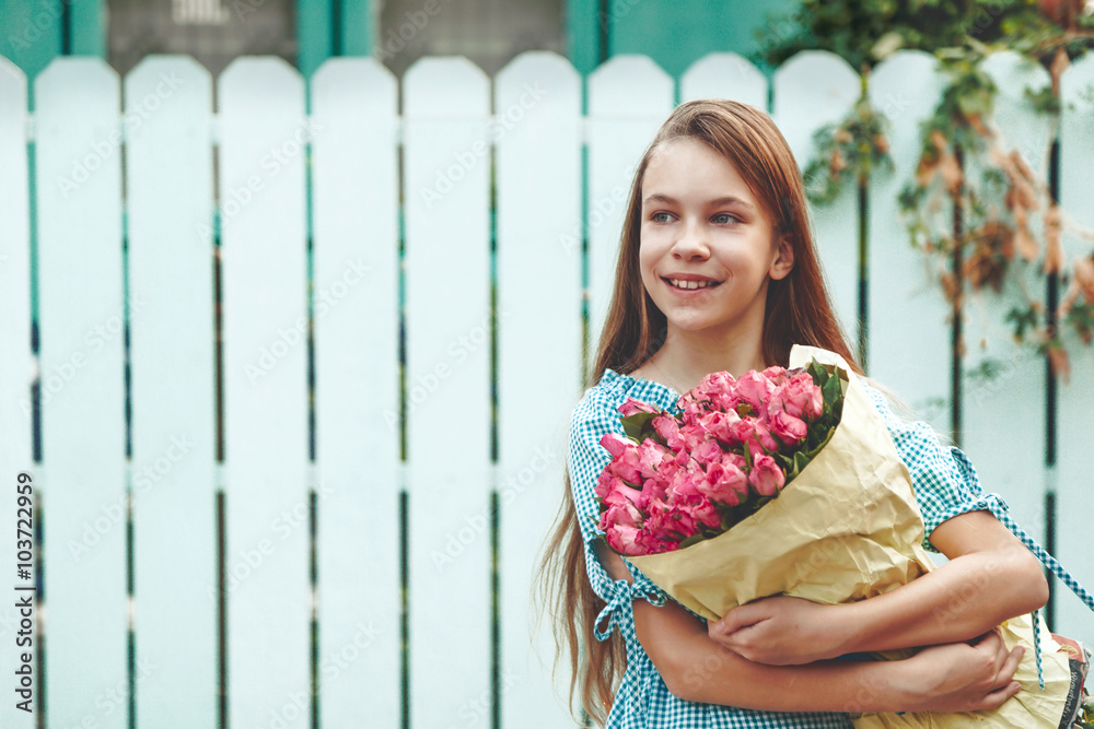 Tween girl holding bunch of roses Stock Photo | Adobe Stock
