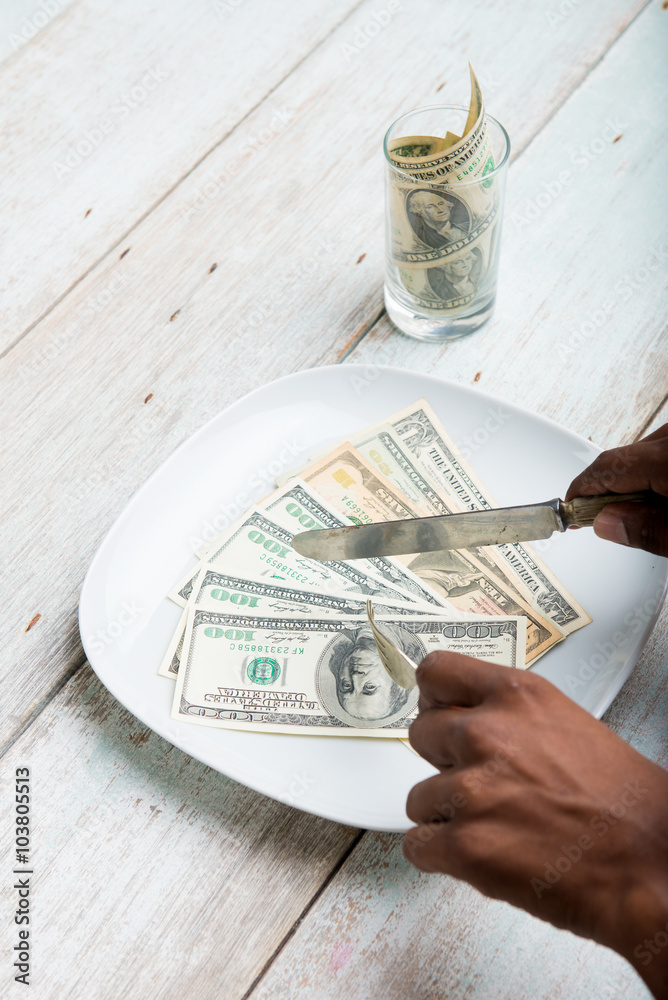 hand eating banknotes symbolising consumerism and corruption Stock ...