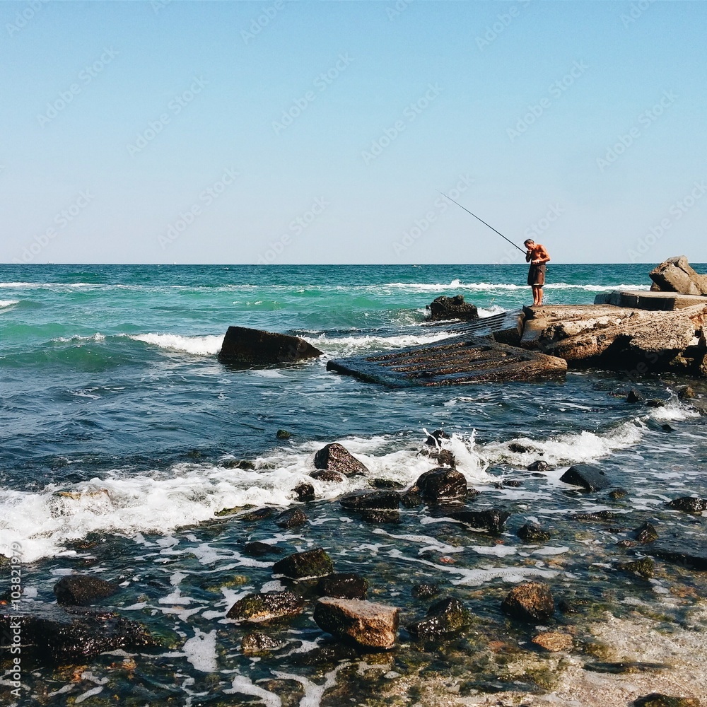 Man fishing on the sea Stock Photo | Adobe Stock