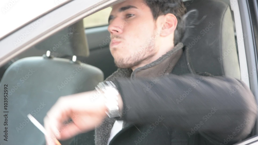 Young Man smoking cigarette while Driving Stock Video | Adobe Stock