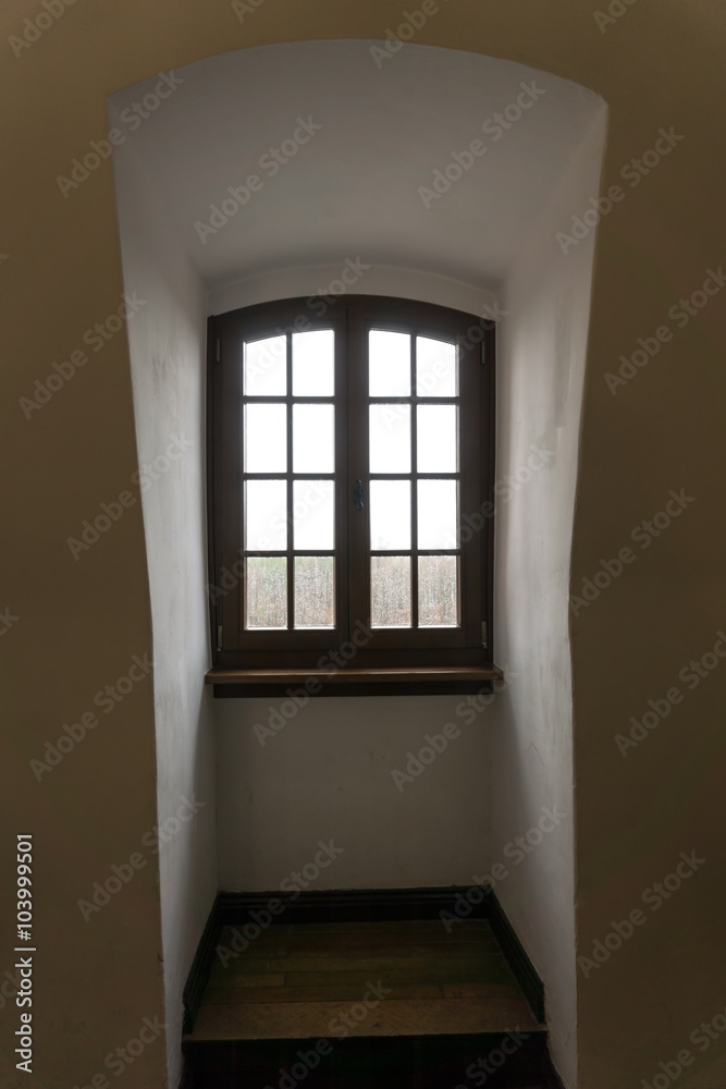 Old window of medieval castle with wooden frame. Thick wall. Rain drops ...