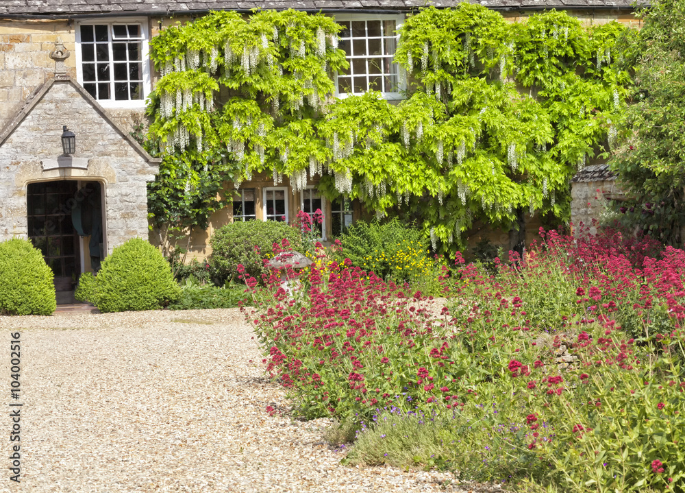 Traditional English cottage courtyard with gravel driveway, stone ...