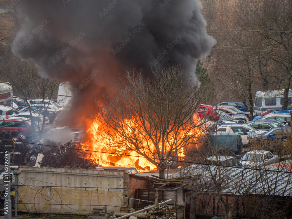 Accident dangerous fire with dark black and grey smoke at car service ...