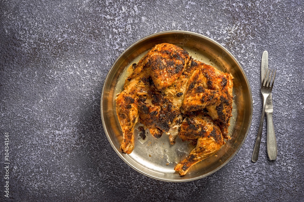 Fried chicken on a tray. Chicken tobacco or chicken tapaka. Georgian ...
