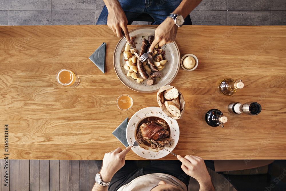Two men in restaurant having lunch Stock Photo | Adobe Stock