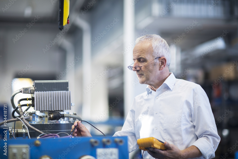 Man controlling device with voltmeter in an industrial hall Stock-Foto ...