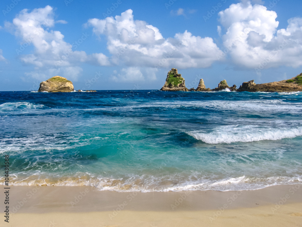 The Salines Bay beach in front of the cliffs of Castle Point located in ...