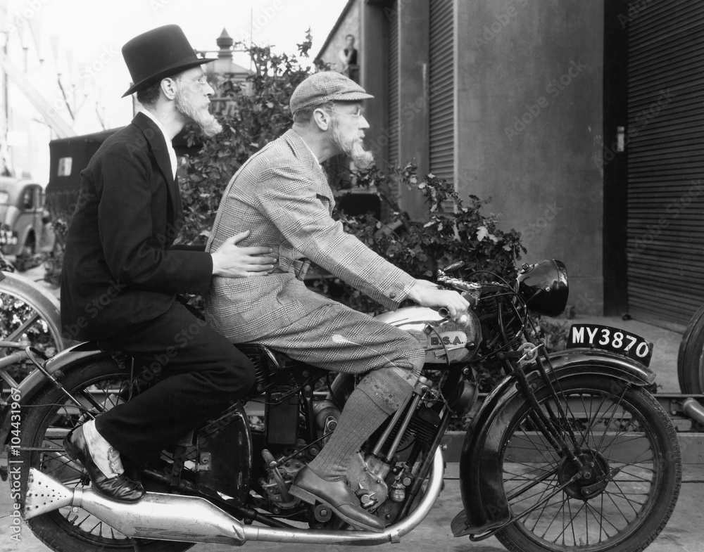 Two men riding a motorbike Stock Photo | Adobe Stock