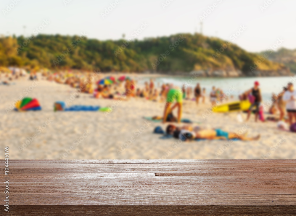 Wood table top on blurred sea and sand beach with some people in Stock ...