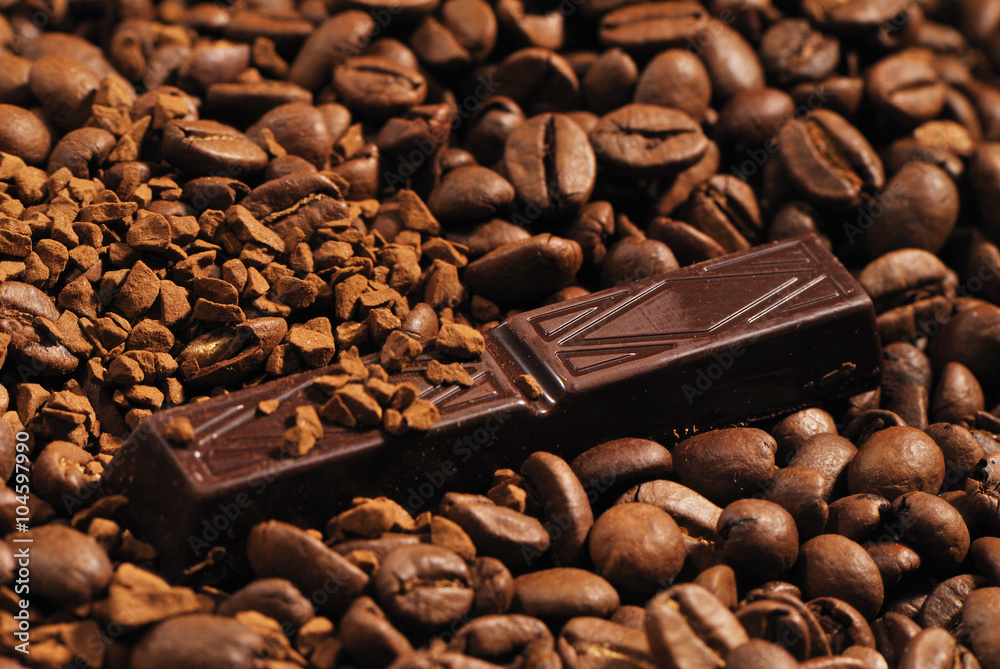 chocolate bar lying on instant coffee and coffee beans Stock Photo ...