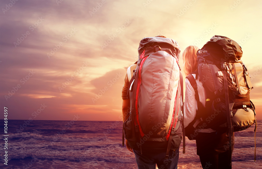 traveler with backpack walking over bright and sunlight with sea sunset ...