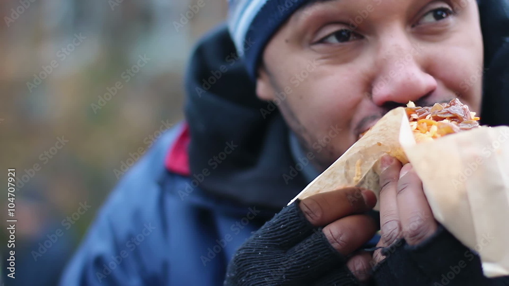 Male junk food addict biting and chewing greasy hot dog, unhealthy ...
