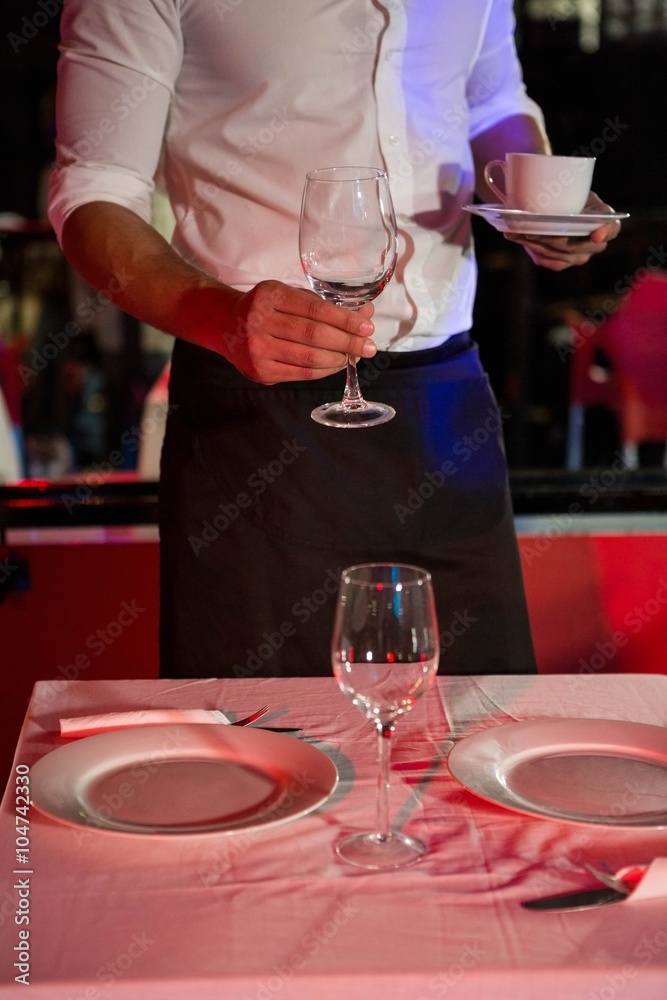Waiter setting a table Stock Photo | Adobe Stock