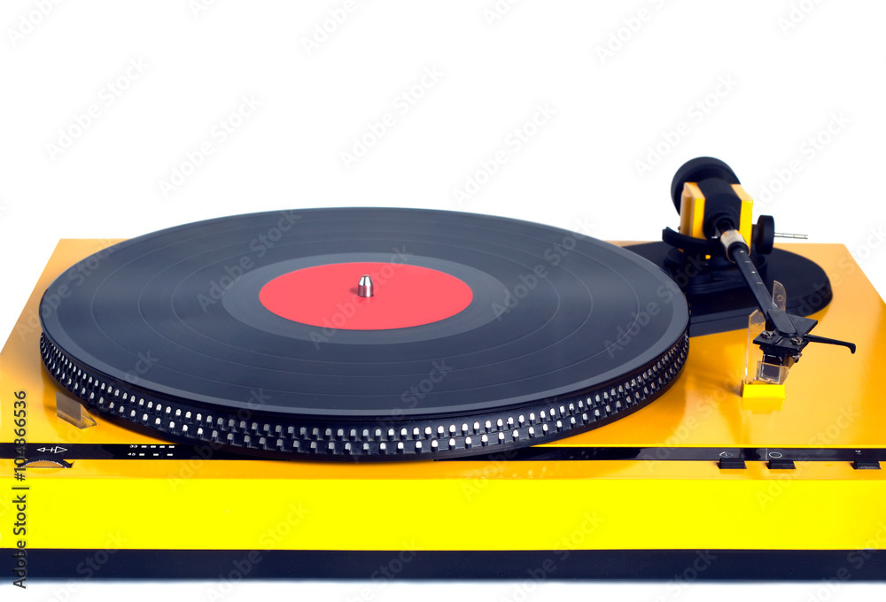 Turntable in yellow case with black vinyl record with red label on disc ...
