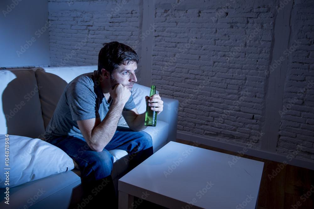 young television addict man sitting on home sofa watching TV and ... young television addict man sitting on home sofa watching TV and ...