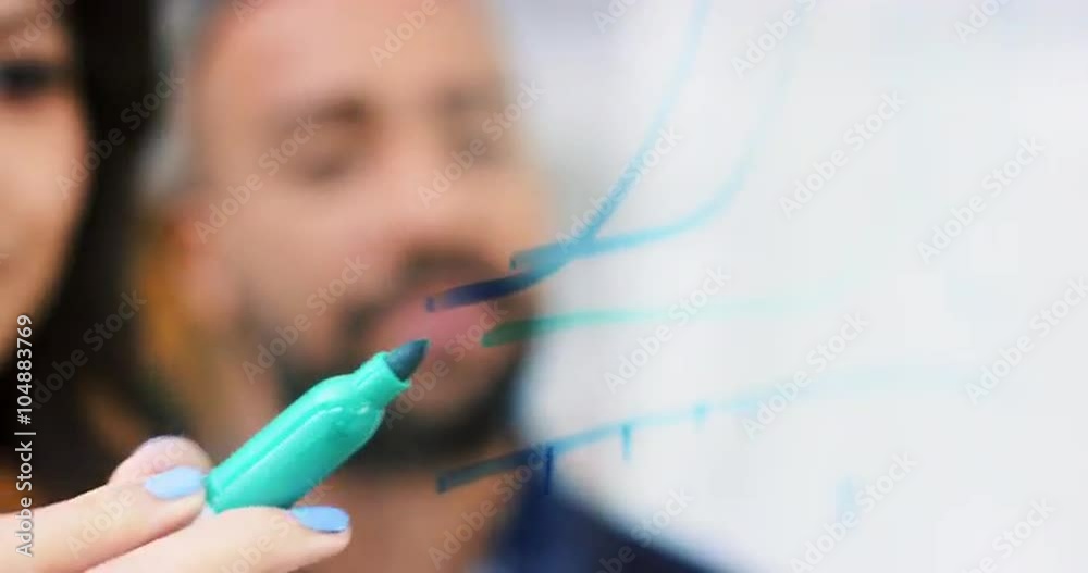 Female engineer drawing graph on glass showing mathematical formula in ...