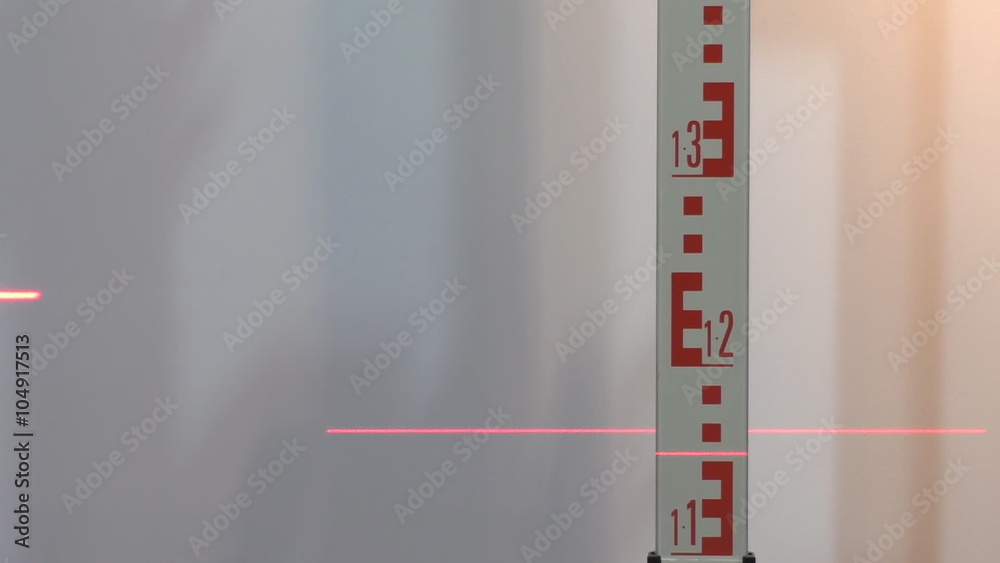 Laser level red light beam line and surveying staff or grade rod Stock ...