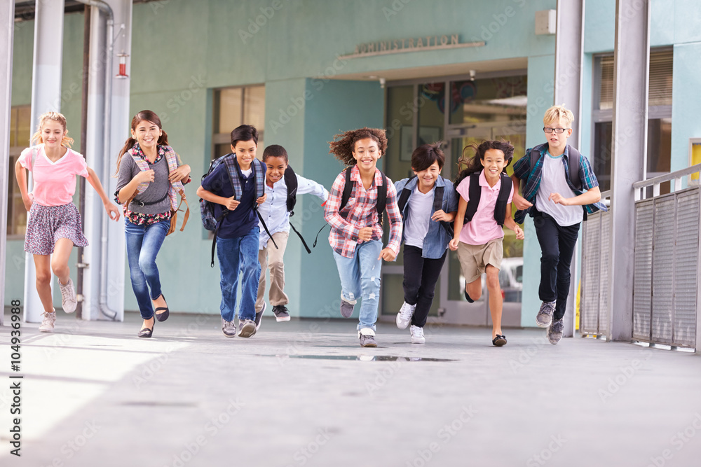 Group of elementary school kids running in a school corridor Stock ...