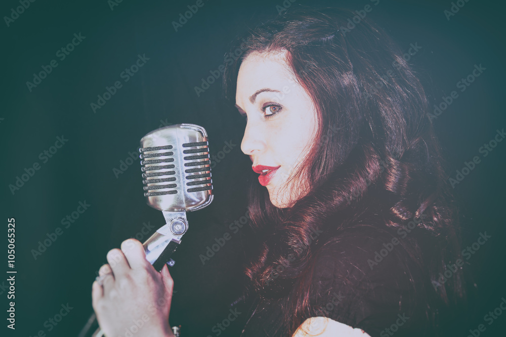 Attractive Girl with Vintage Microphone. Attractive female singing into ...