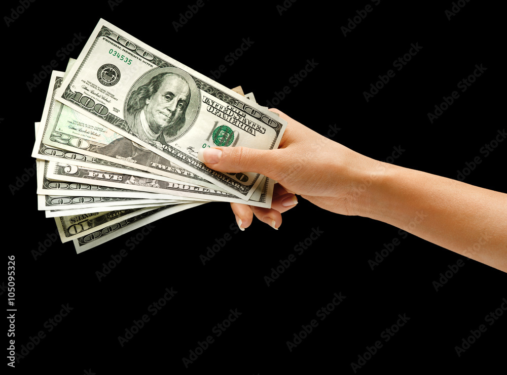 Woman's hand holding money isolated on black background Stock Photo ...
