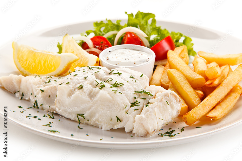 Fish dish - boiled fish fillet, baked potatoes and vegetables Stock ...
