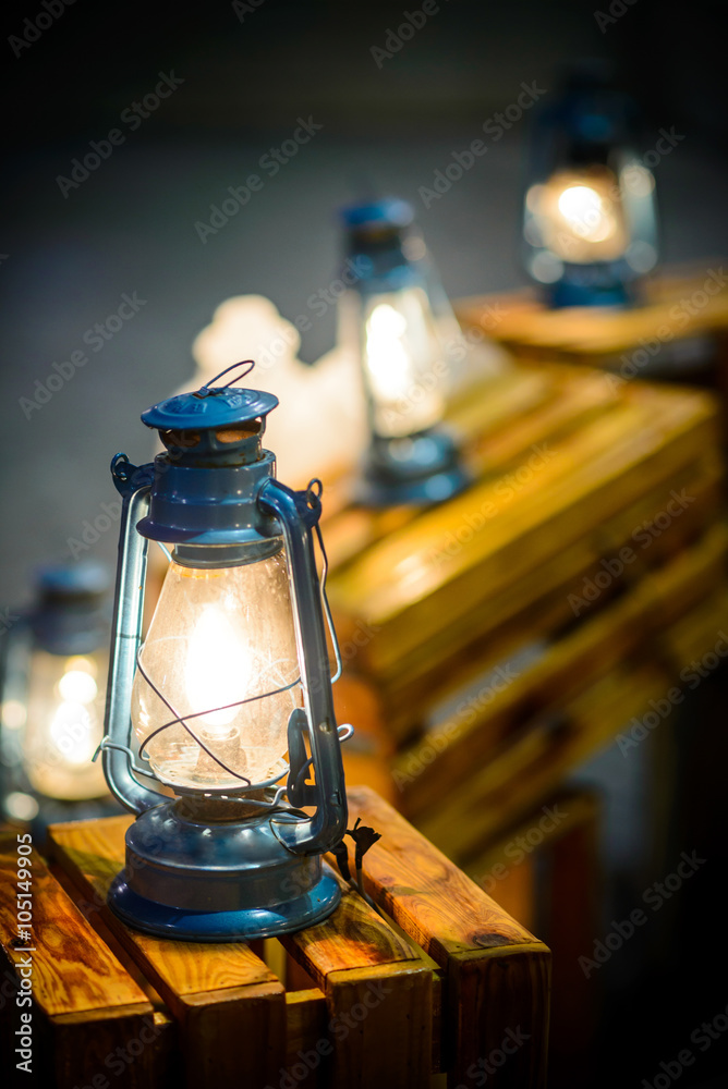 Vintage fashioned rustic kerosene oil lantern lamp burning with a soft ...