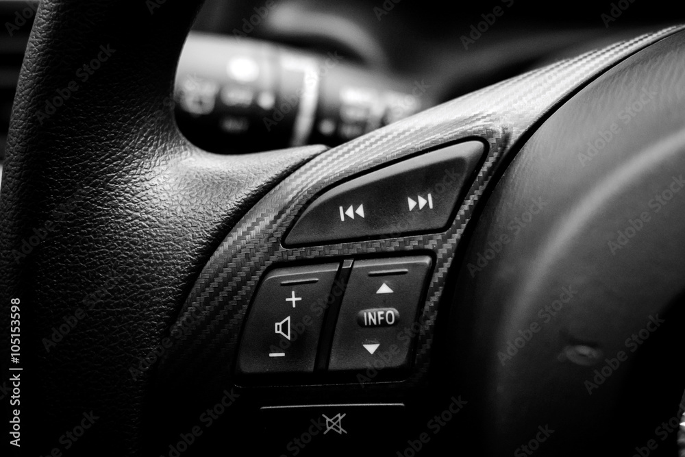 Foto de Close up of steering wheel of modern car. Volume and telephone ...